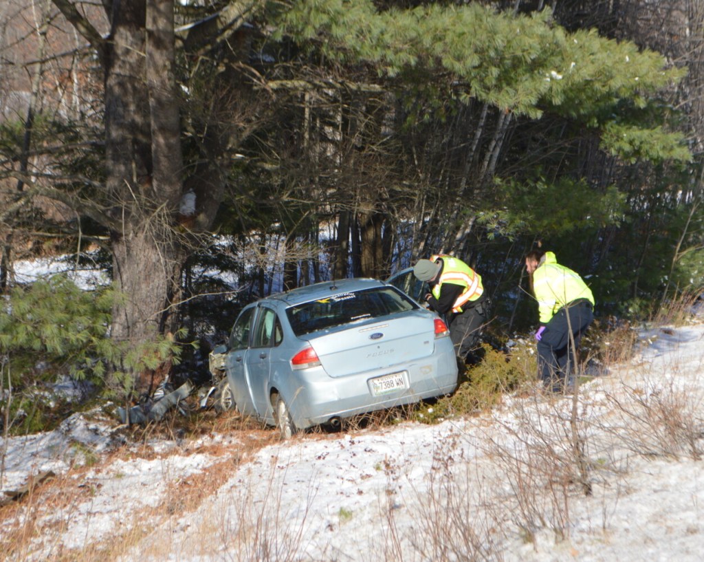 PHOTOS: Car hits sign, crashes in Wilton